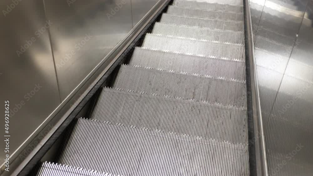 Empty working escalator. POV escalator footage from top to bottom ...