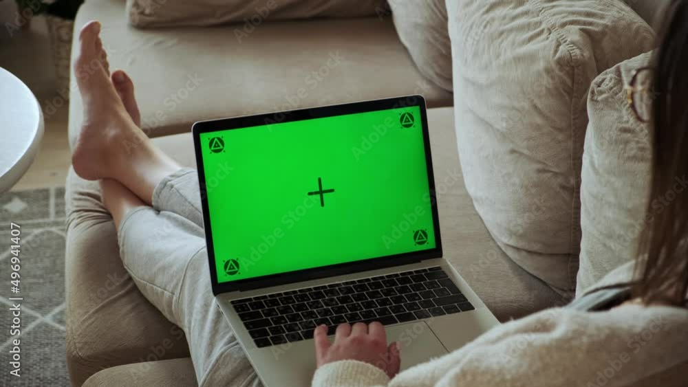 Woman using laptop green screen chroma key, working with touch pad ...