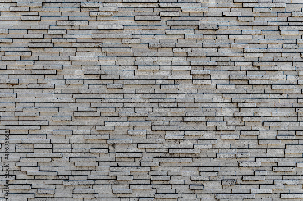 Gray brick wall. Background of rectangular gray tiles of different ...