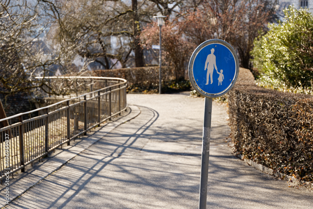 blue footpath sign, traffic sign, white painted man with child on blue ...