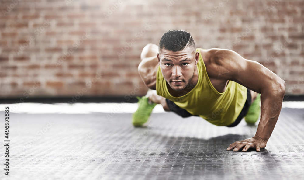Executive the perfect one-handed pushup. Full length shot of a young ...
