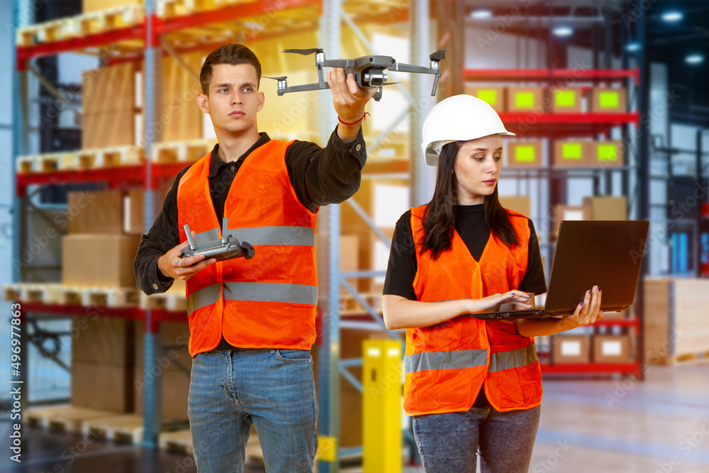 Modern warehouse technologies. Guy and girl are working in warehouse ...