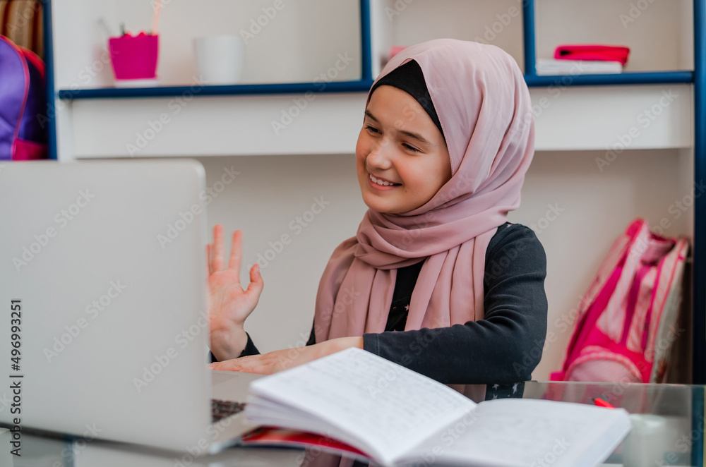 Smiling Muslim student girl having video call with tutor, study online ...