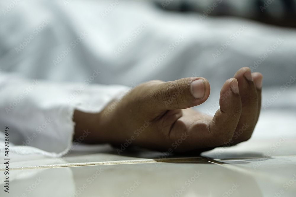 dead body laying on a floor.Focus at the Hand Stock Photo | Adobe Stock