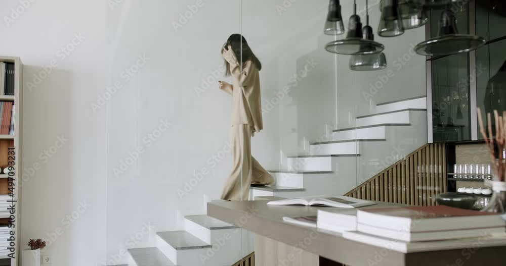 Slow motion photo of a young independent Caucasian woman descending the ...