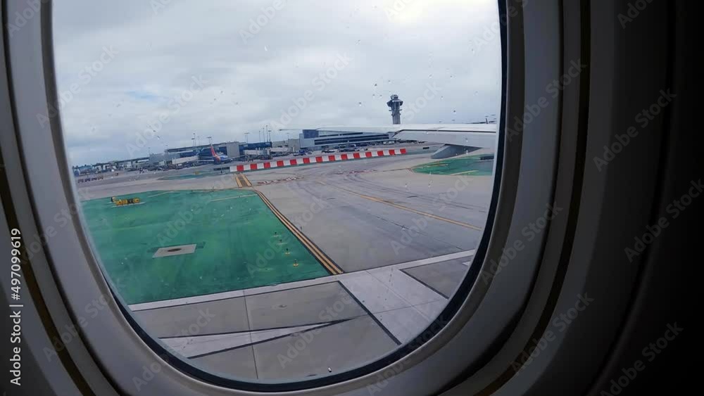 Plane take off. view from the porthole on the wing of the plane ...