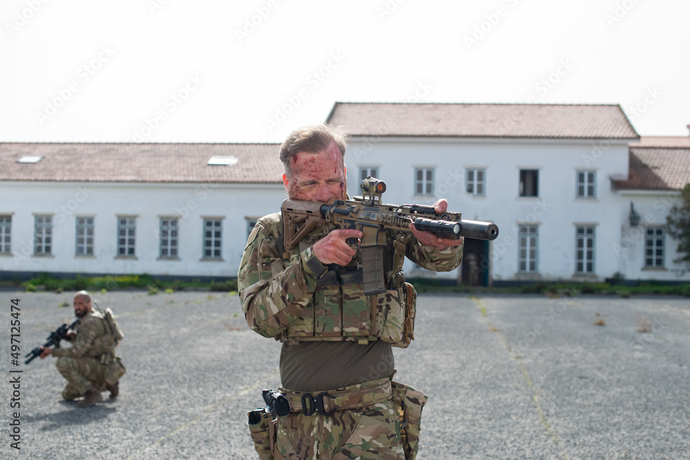 Portrait of bold soldier after battle. Man with blood smears on face ...