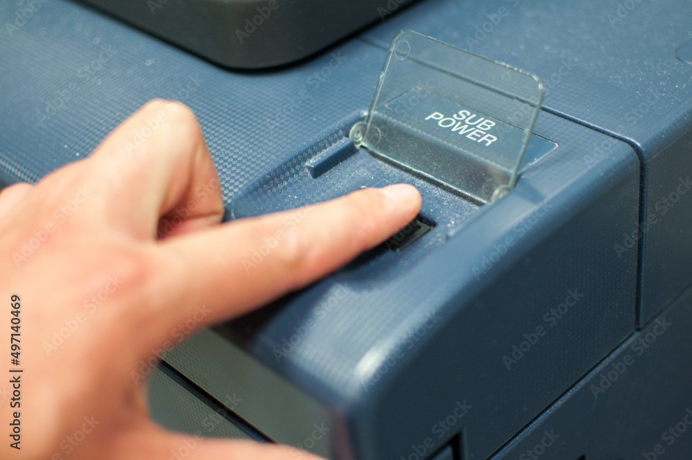 Printing machine control panel with start buttons. Worker's hand ...