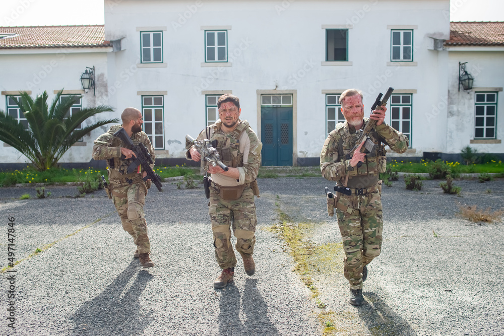 Portrait of brave soldiers during battle. Men with blood smears on ...