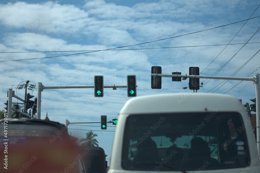 Green light traffic light with go forward sign in a sunny summer day ...