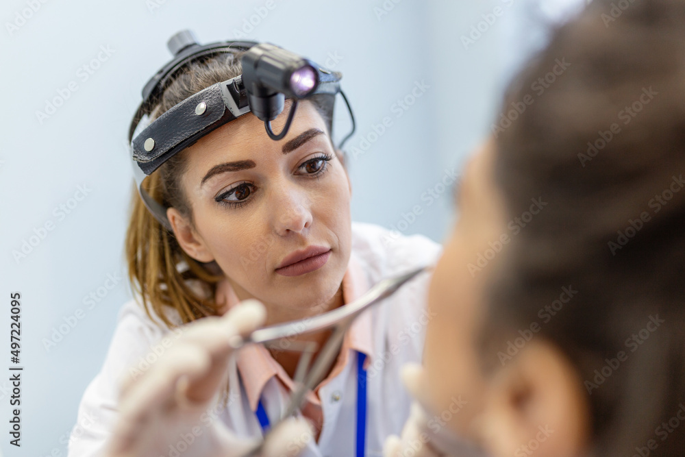 Otolaryngology concept. Positive woman otorhinolaryngologist checking ...