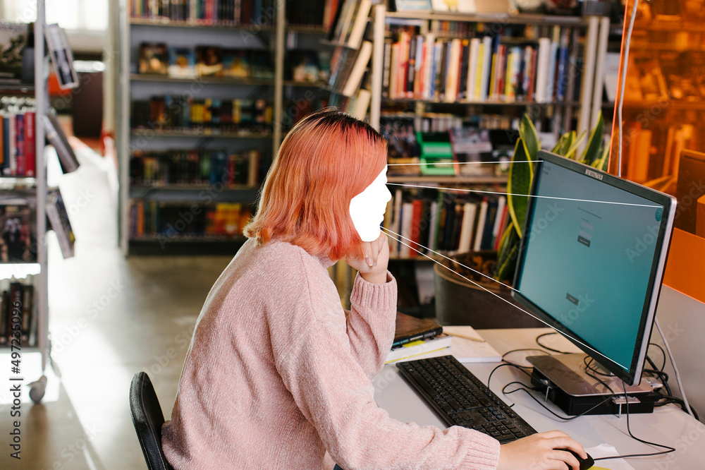 Female student using computer in library Stock Photo | Adobe Stock