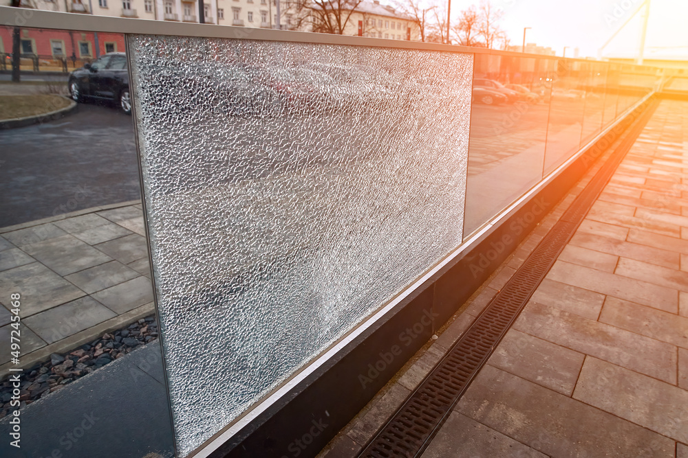 Glass fence with broken glass, damaged shockproof fencing on office ...