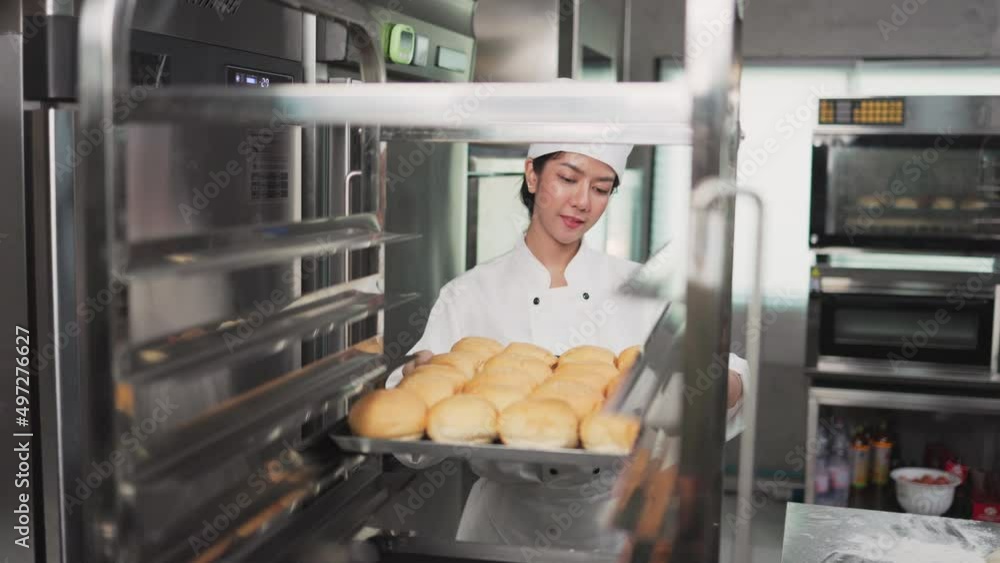 Smiling asian female bakers looking at camera..Chefs baker in a chef ...