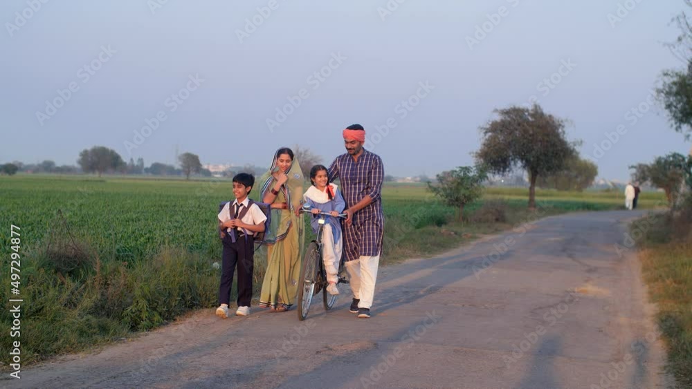 A small nuclear family in an Indian village - Village couple dropping ...