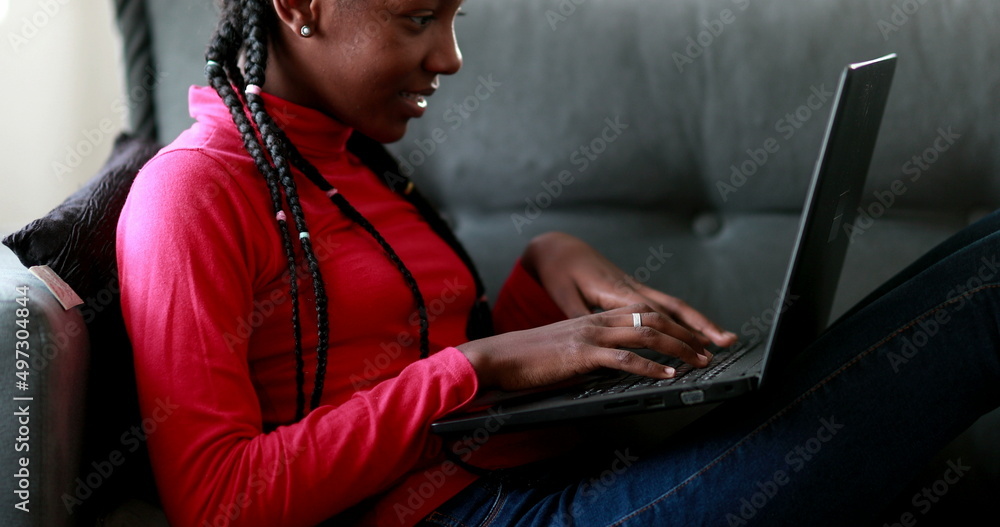 Happy black African teen girl using laptop computer at home Stock Photo ...