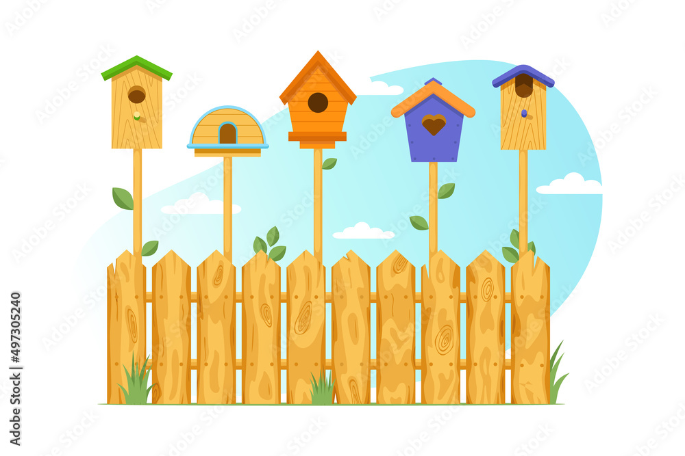 Wooden multi-colored birdhouses behind pretty garden fence. Birdhouse ...