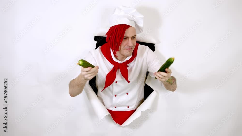 Young insane man dressed as chef with cucumbers. Crazy male cook with ...