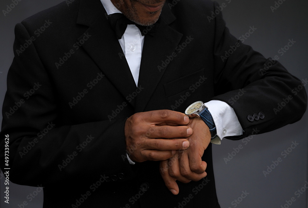 man with wrist watch on hand telling the time on grey background with ...