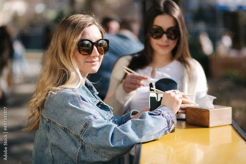 Daily routines of two female colleagues on lunch break. Blond and brown ...
