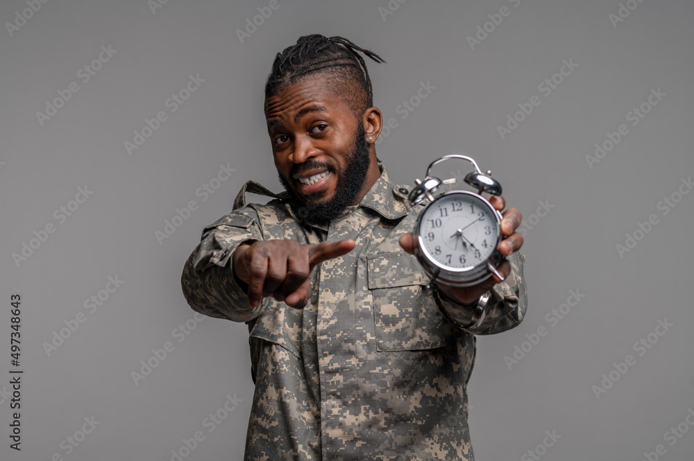 Soldier showing his mechanical wind-up twin bell alarm clock Stock ...