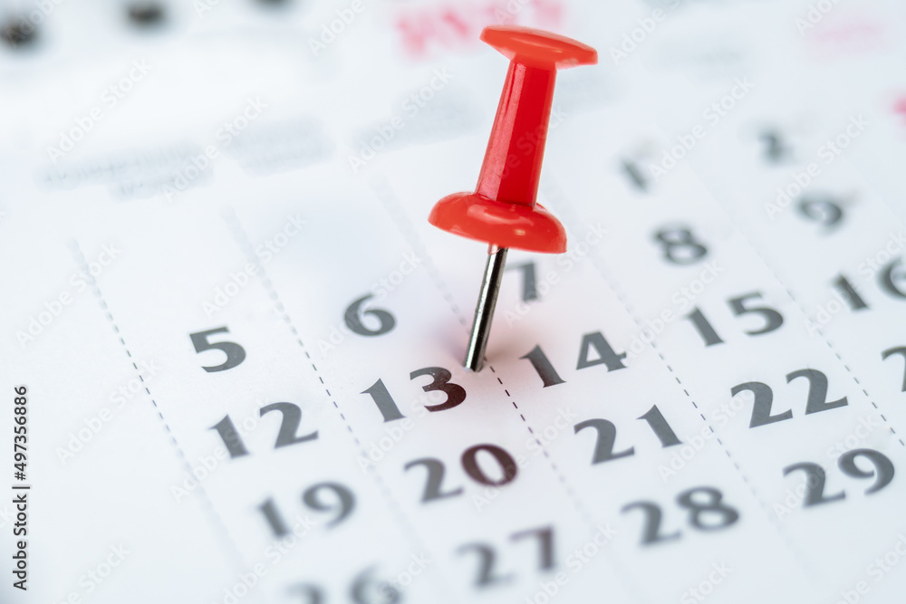 Red push pin on calendar 13th day of the month, mark the Event day with ...