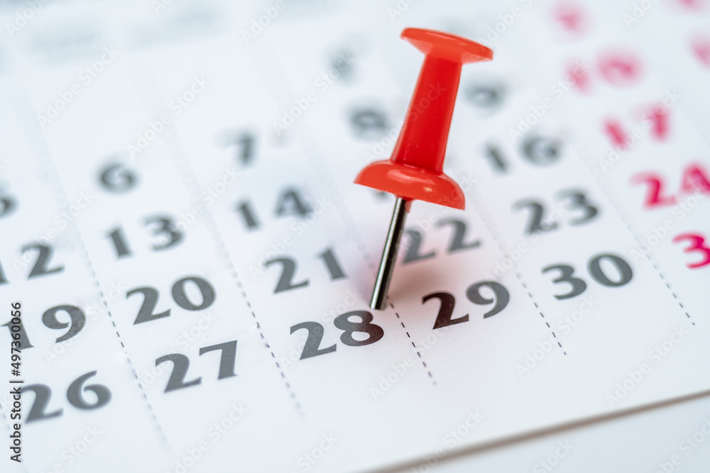 Red push pin on calendar 28th day of the month, mark the Event day with ...