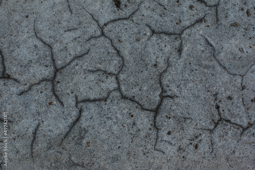 Texture of the dried earth. Dark gray background with cracks and ...