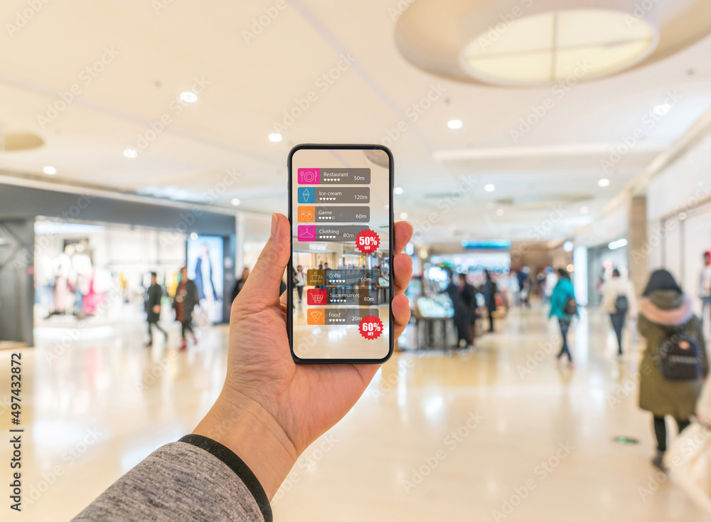 Augmented reality marketing in the shopping mall. Hand holding smart ...