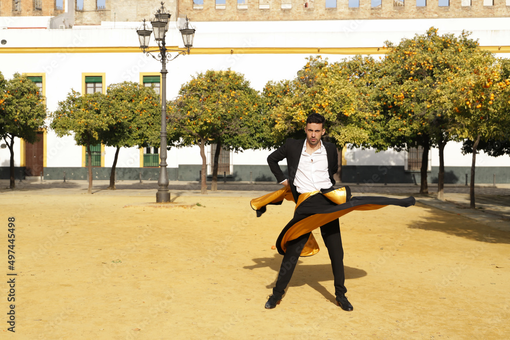 Young Spanish man in black shirt, jacket and pants, with dancing shoes ...
