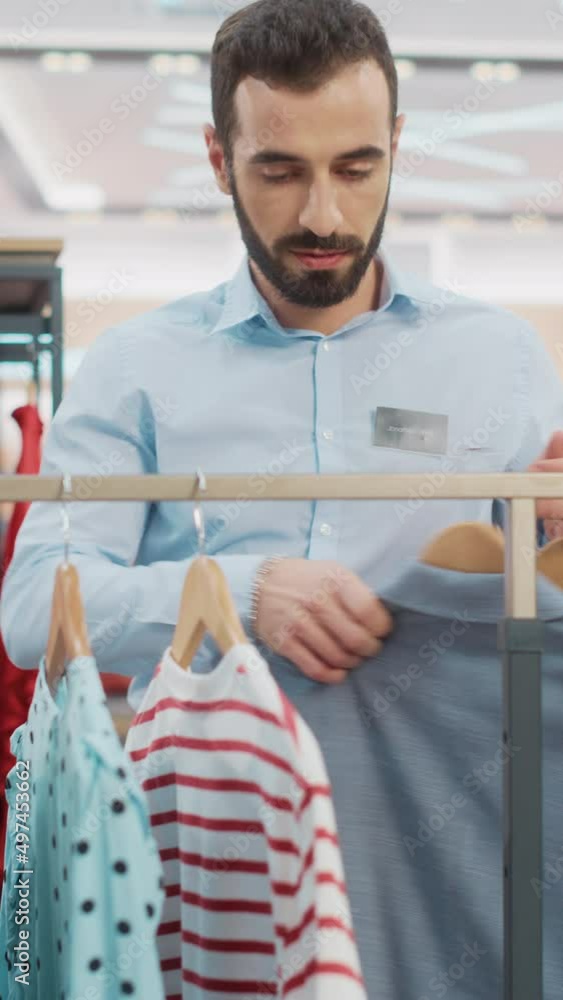 Vertical Portrait of a Handsome Male Clothing Store Assistant Working ...