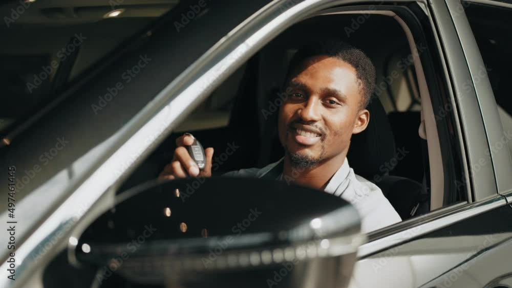 Man sitting inside his luxury car with keys in hands. Handsome man ...