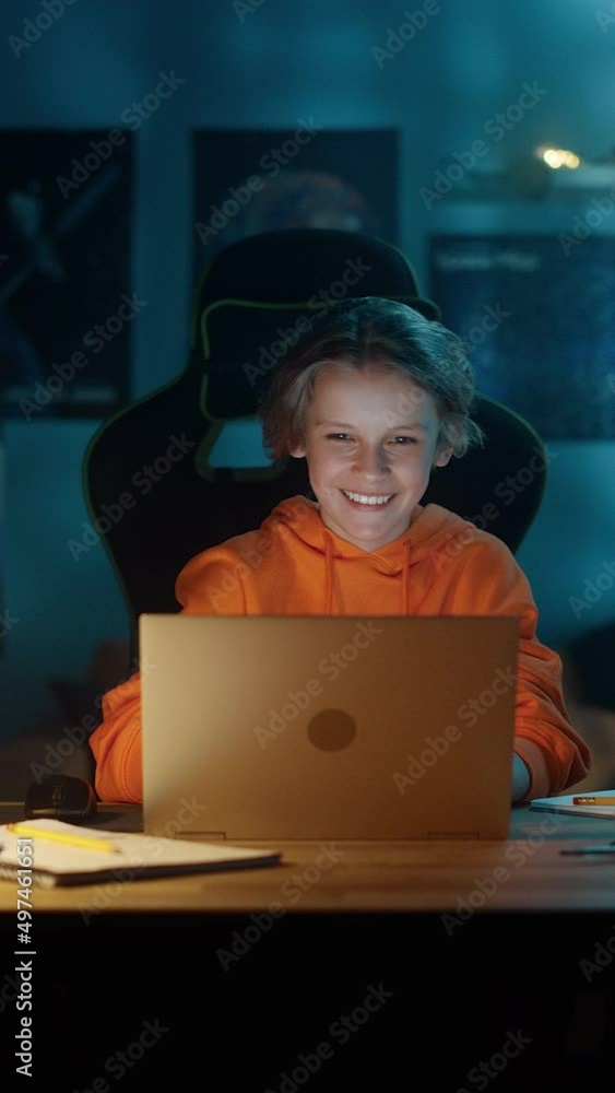 Vertical Portrait of a Smart Young Boy Using Laptop Computer in a Dark ...
