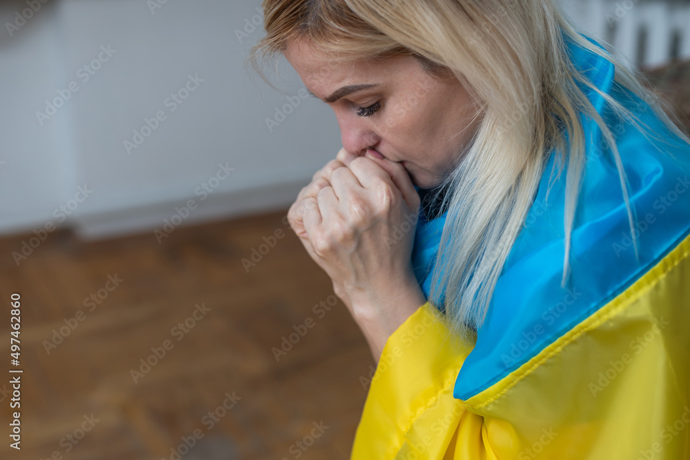 Crying sad depressed frightened emotional woman with Ukraine flag. Stop war between Russia and ...