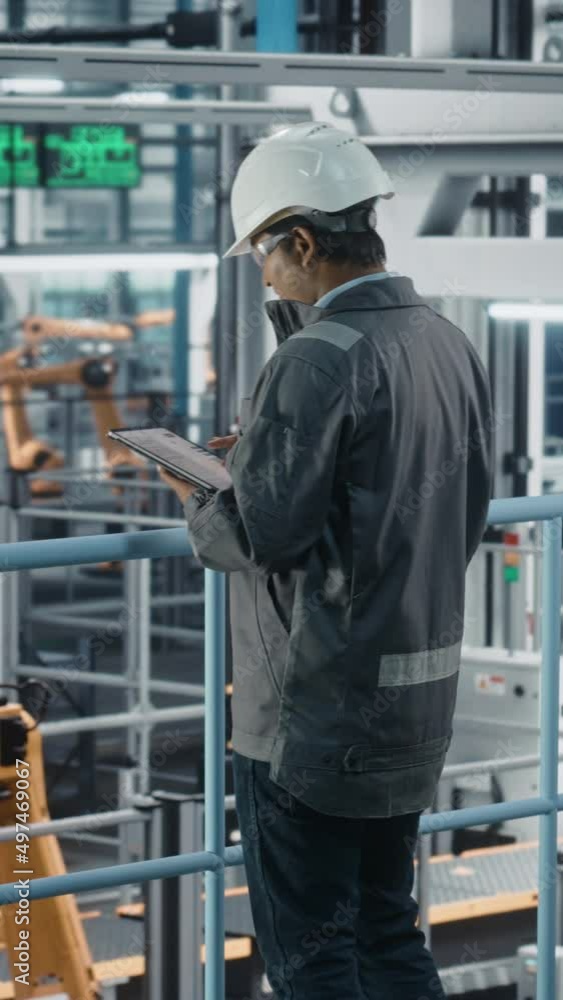 Vertical Footage of Car Factory Engineer in Work Uniform Using Laptop ...