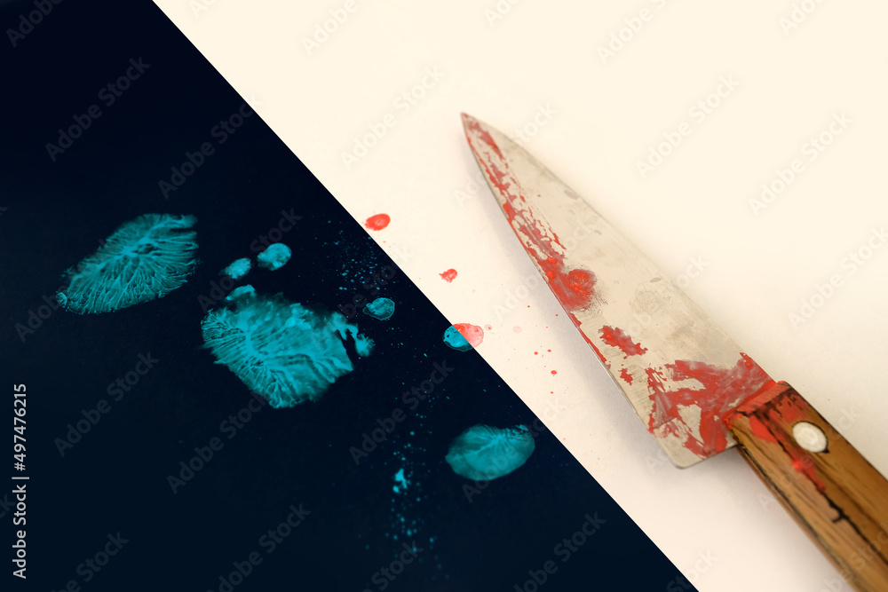crime scene, idfresh splatter of red blood on knife on white table ...