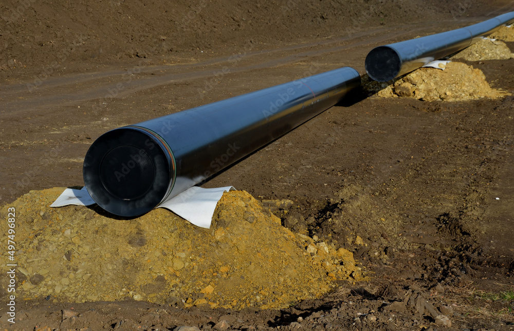 installation of gas pipelines in field. excavated topsoil hiding route ...