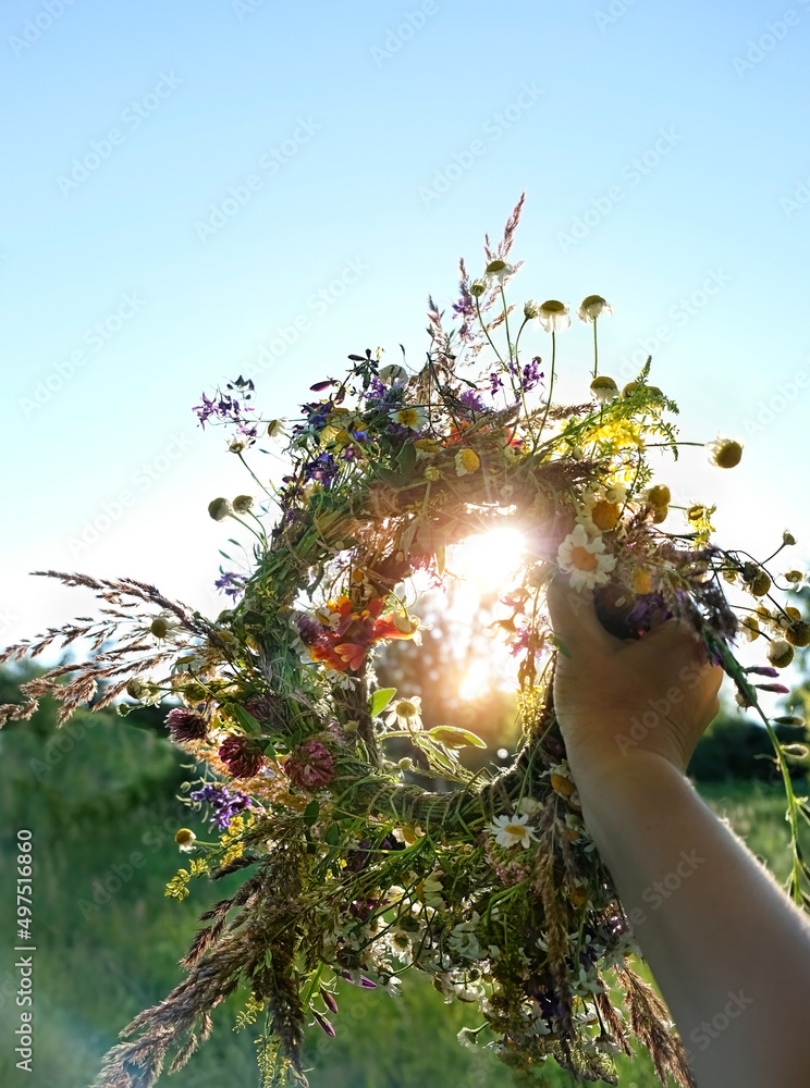 floral wreath in hand, sunny natural background. floral traditional ...