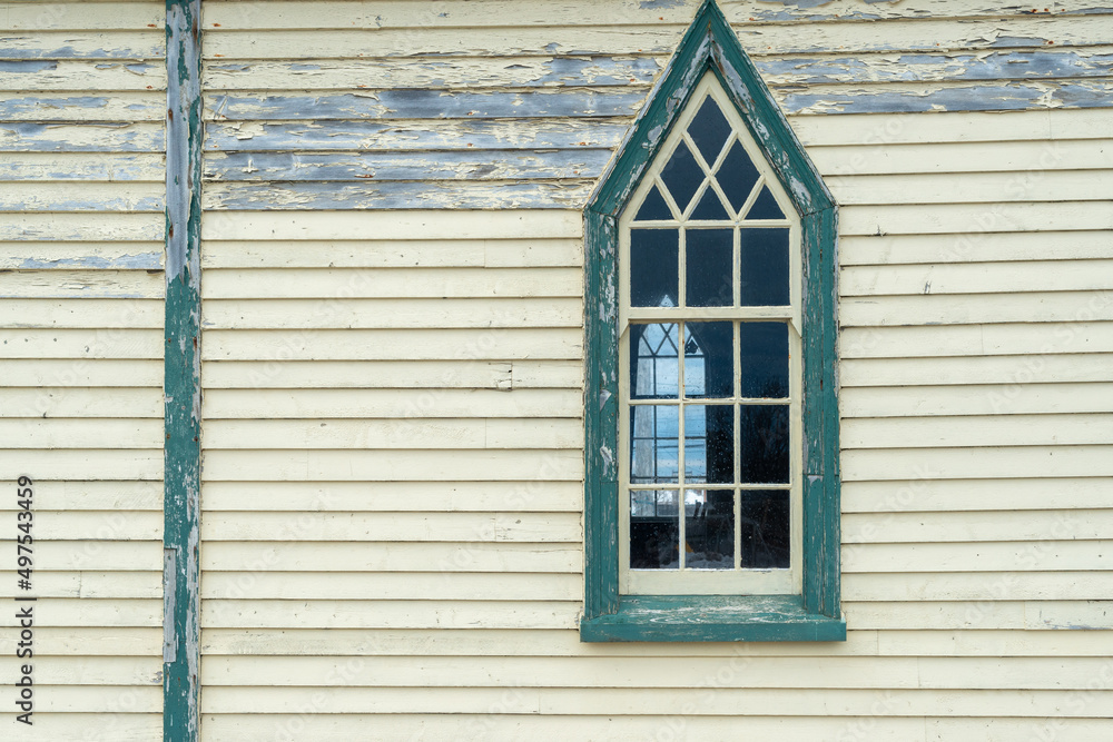 The exterior wall of a religious building with pale yellow colored ...