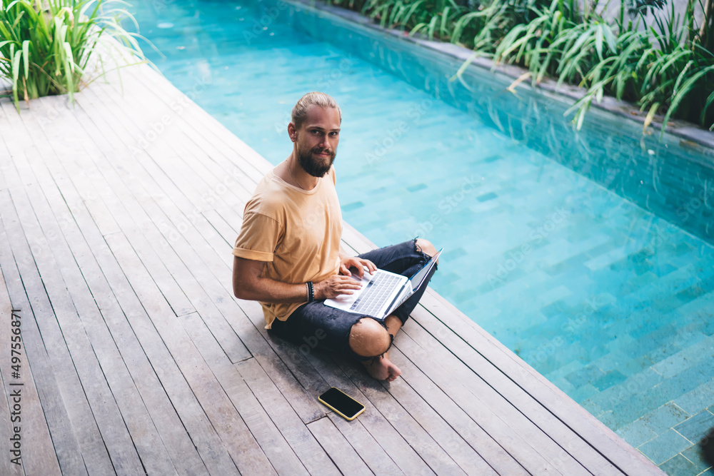 Portrait of Caucasian IT professional looking at camera while doing ...