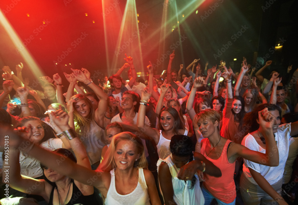 These fans llive to rock. Attractive female fans enjoying a concert ...