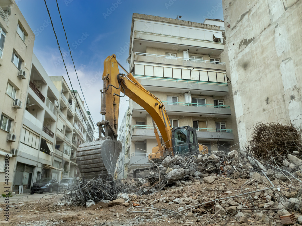 Building demolition excavator with long mechanical arm. Destruction of ...