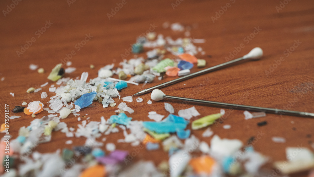 Close up side shot of microplastics for size comparison.. Concept for ...