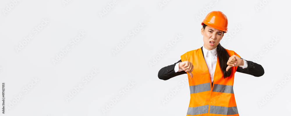 Disappointed and upset asian female chief engineer inspect bad work ...