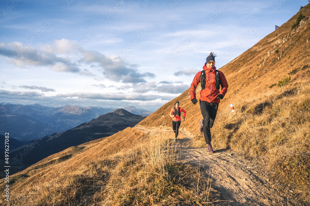 Female runner chasing man through the highlands. Stock Photo | Adobe Stock