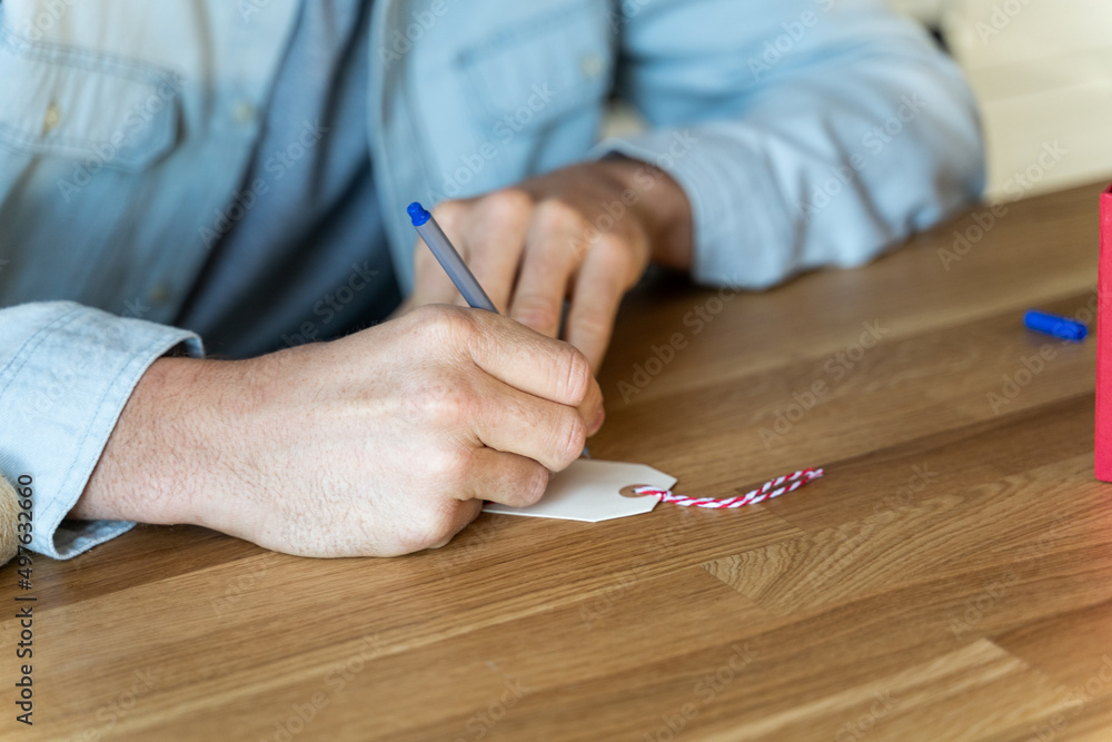 Man writing on gift card Stock Photo | Adobe Stock