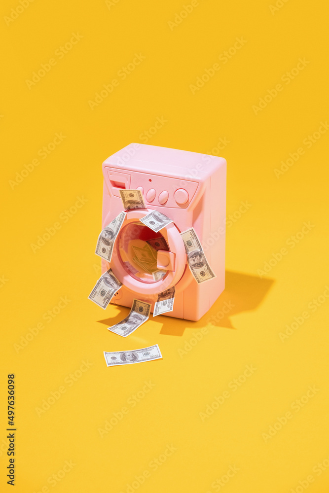 Washing machine washing dollar bills. Stock Photo | Adobe Stock