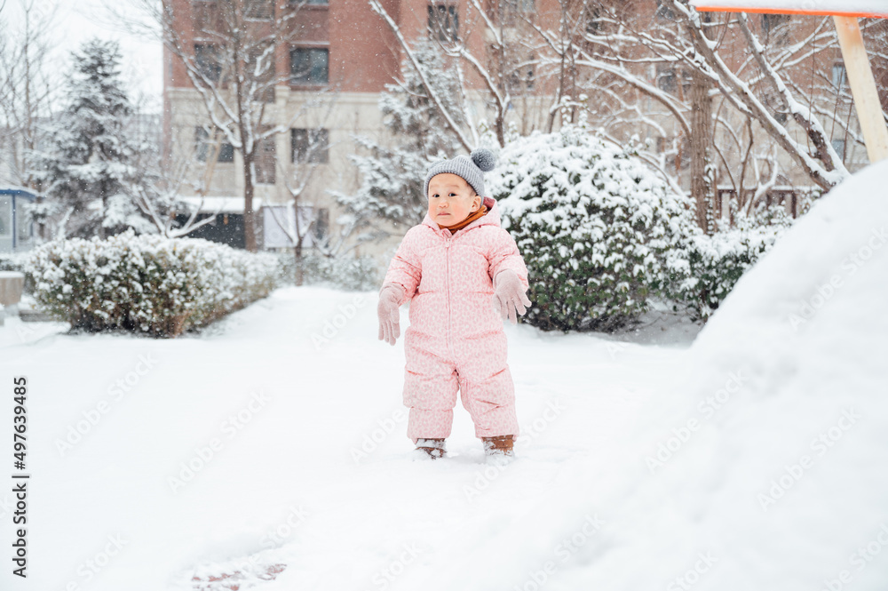 Cute baby playing in snowy day Stock Photo | Adobe Stock