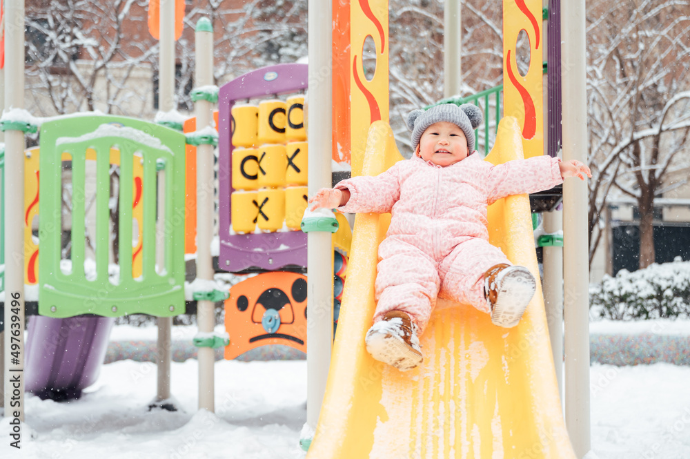 Cute baby playing in the snowy day Stock Photo | Adobe Stock