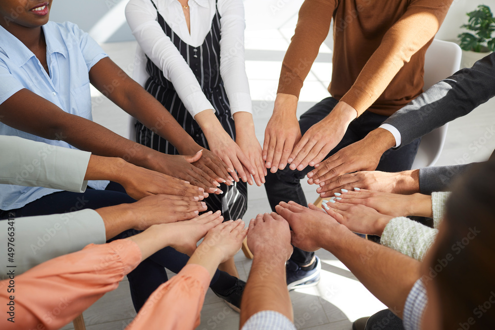 Team of happy diverse people holding hands in a circle. Different young ...